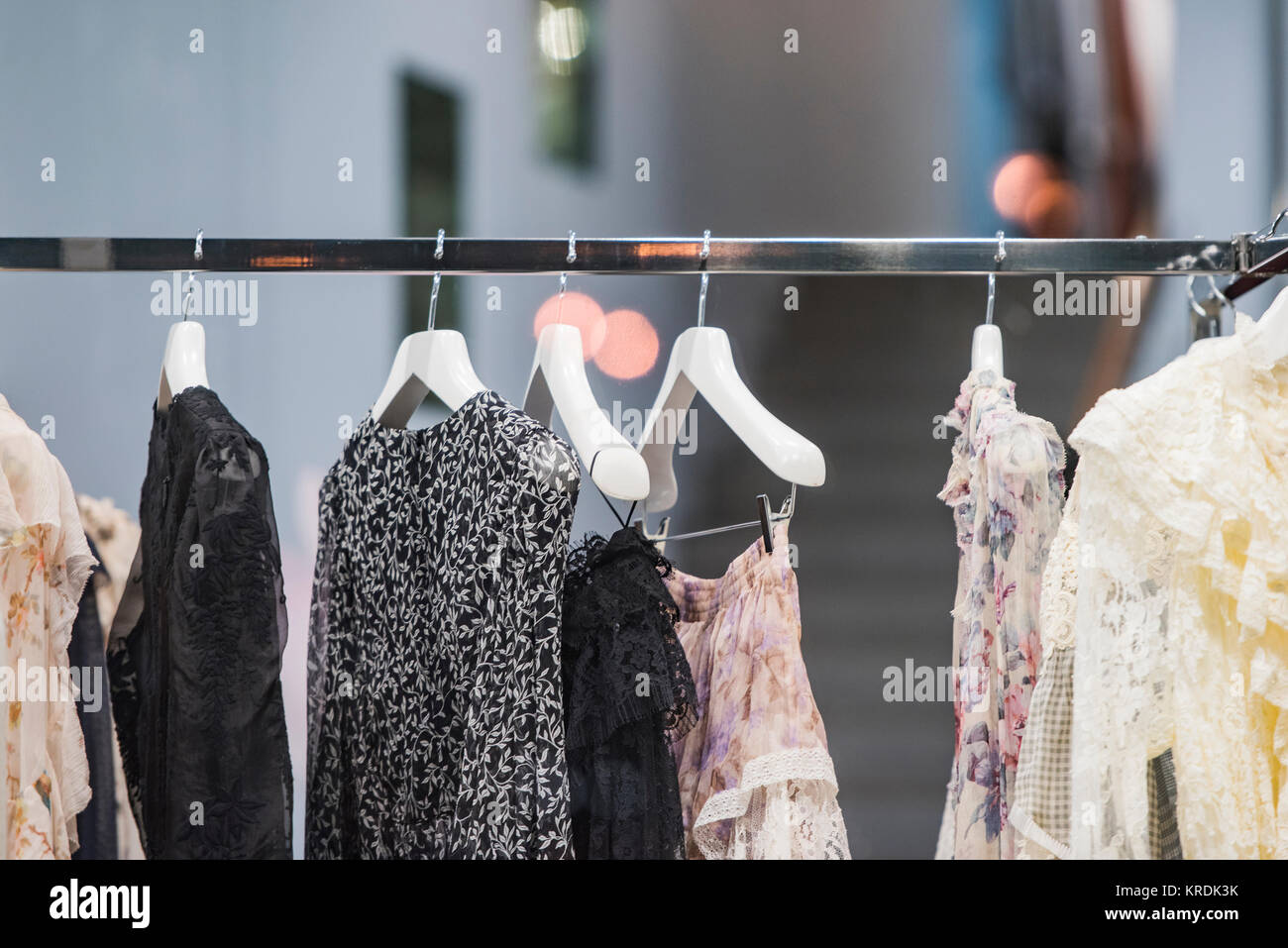 Women clothing on racks in a fashion store Stock Photo - Alamy
