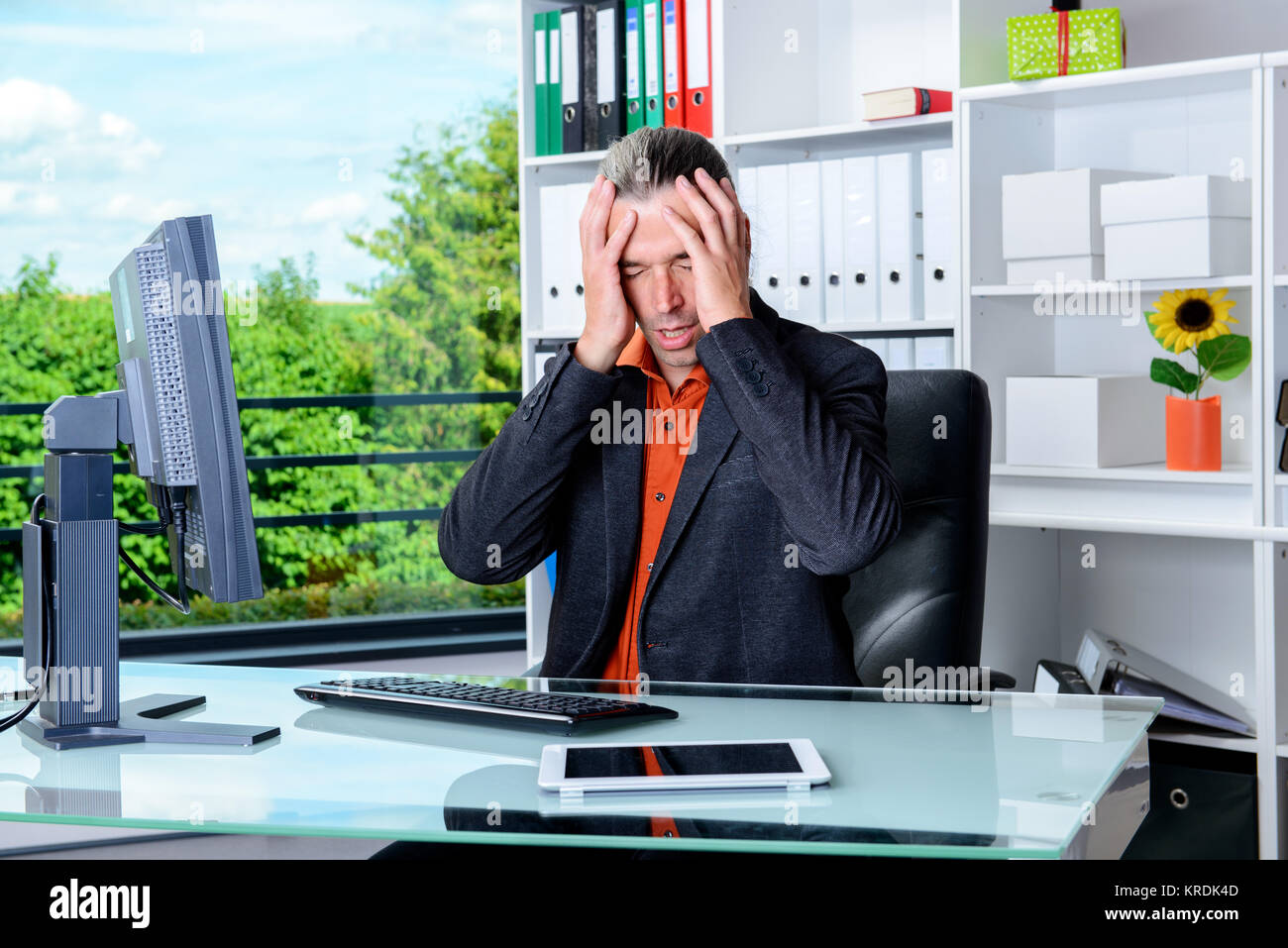 young tired business man lying with head in hands is over-worked Stock ...