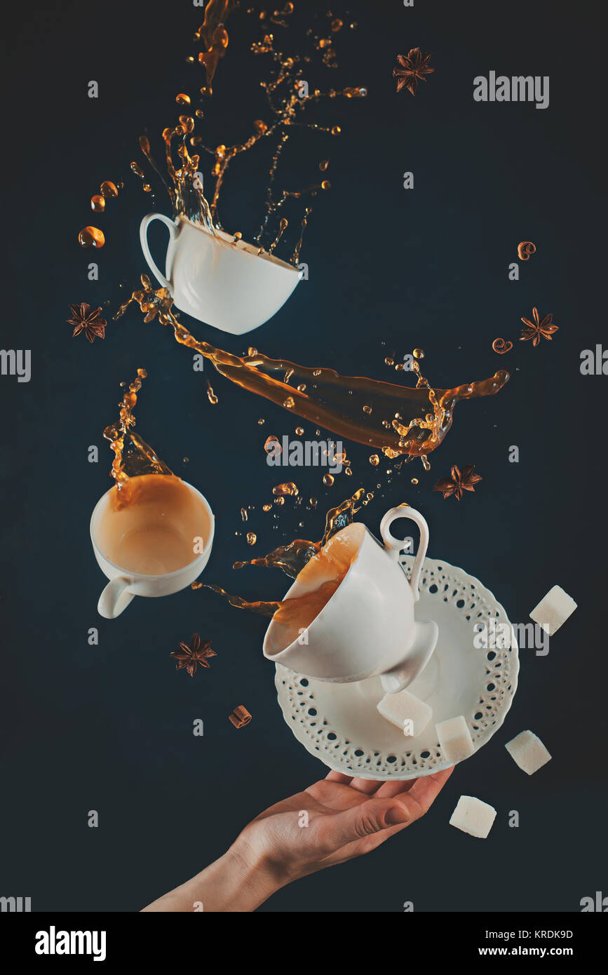 Flying coffee cups with saucer, dynamic splashes and falling sugar ...