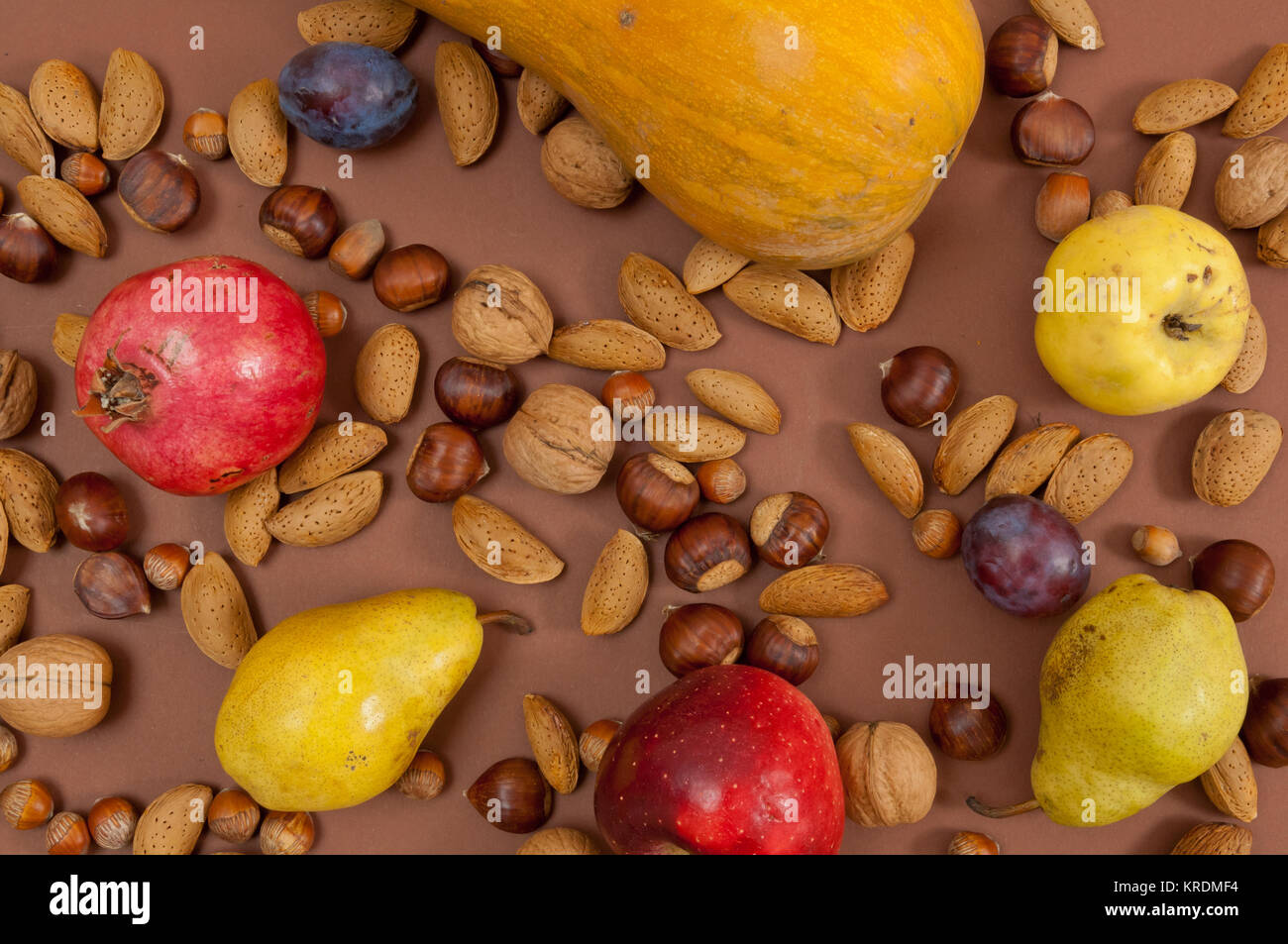 Organic autumn fruits and in shell nuts on brown background Stock Photo ...