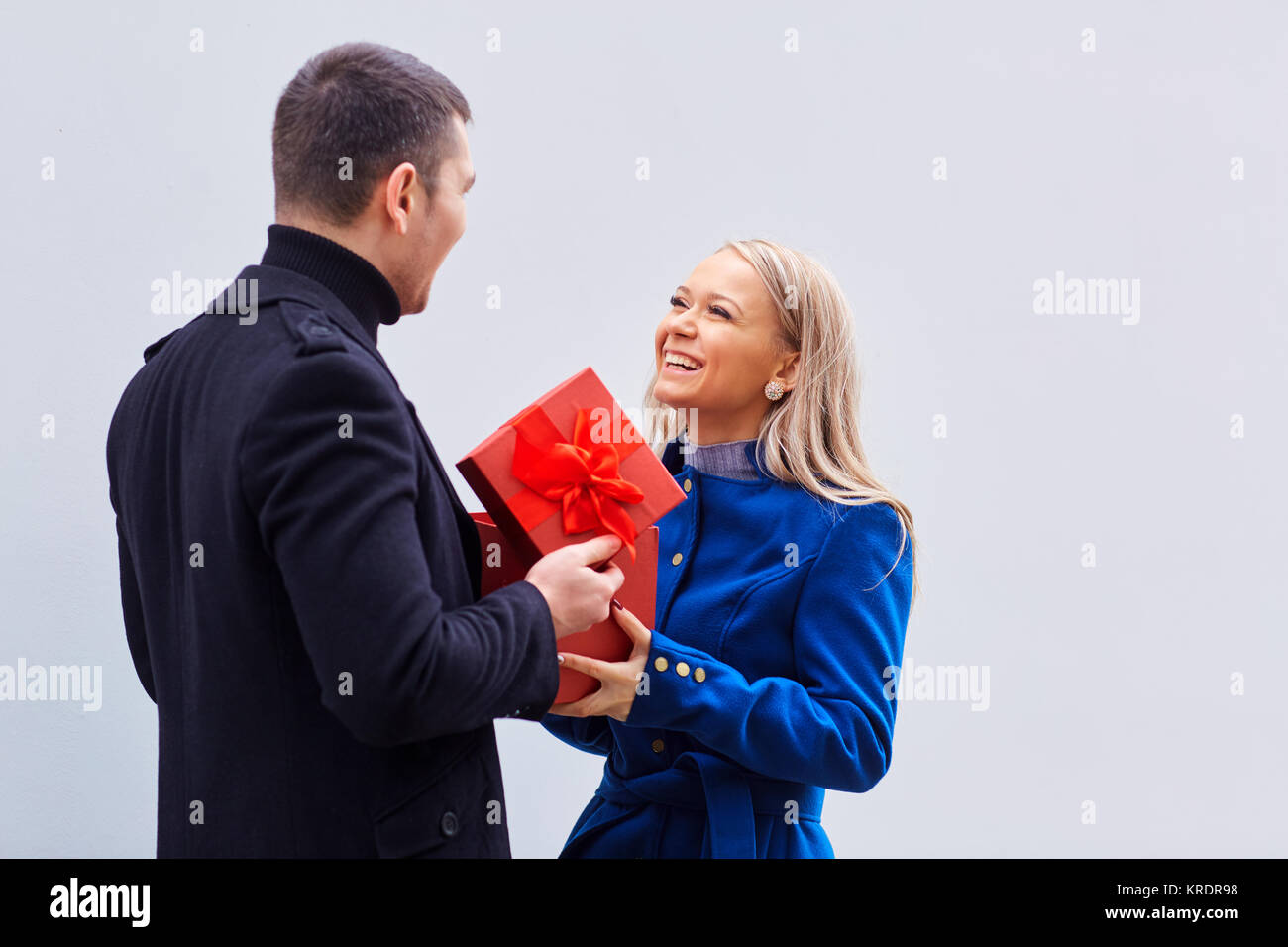 A loving couple gives a gift in a box Stock Photo - Alamy