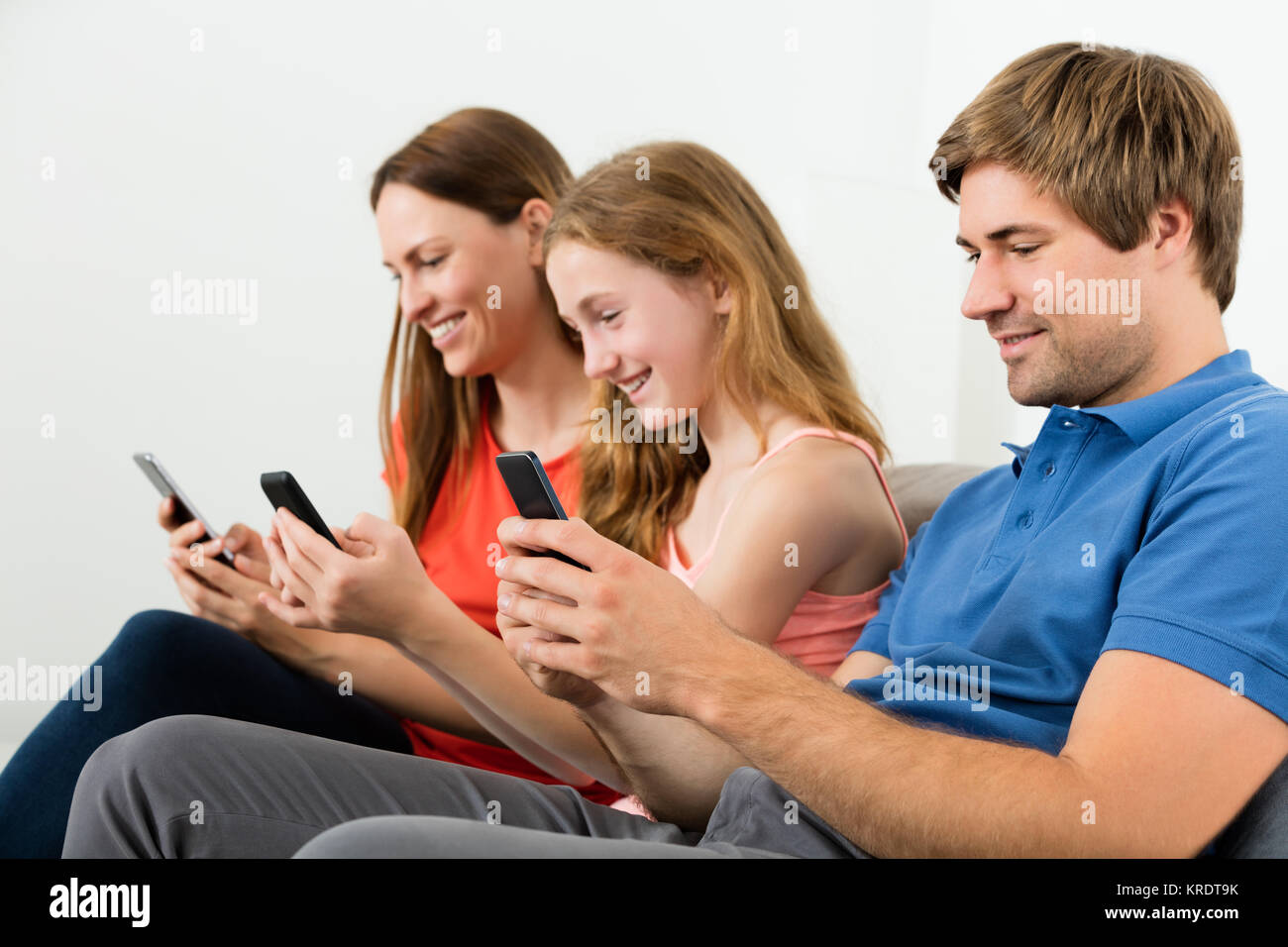 Family Using Mobile Phone Stock Photo - Alamy
