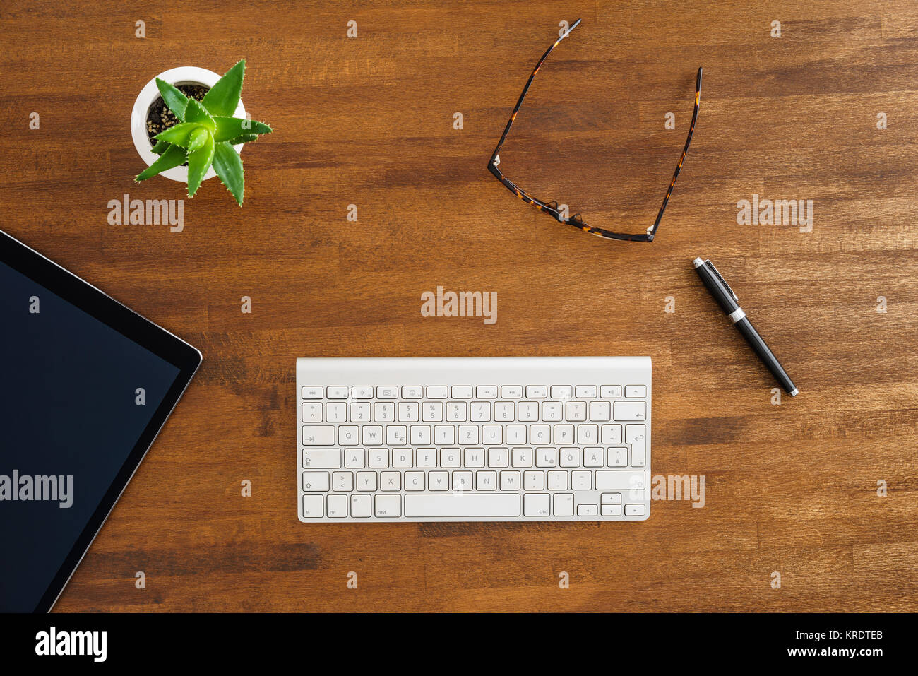 Desktop scene on wooden table Stock Photo - Alamy