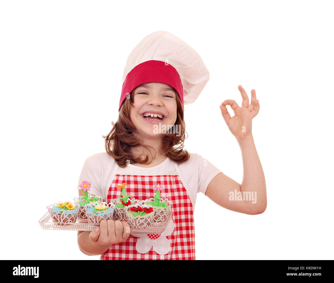 happy little girl cook with muffin and ok hand sign Stock Photo - Alamy