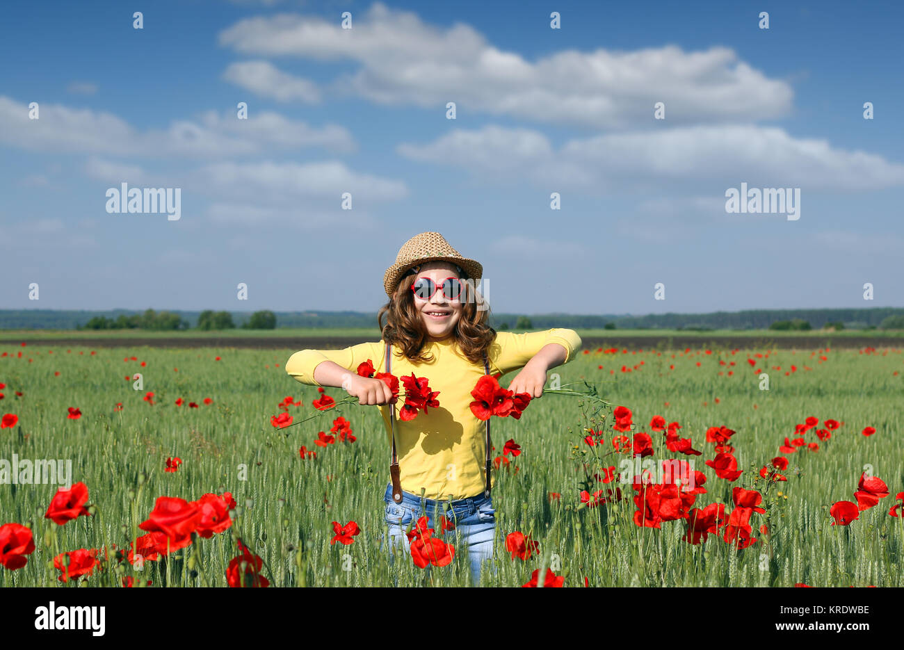happy little girl on poppies flower field Stock Photo - Alamy