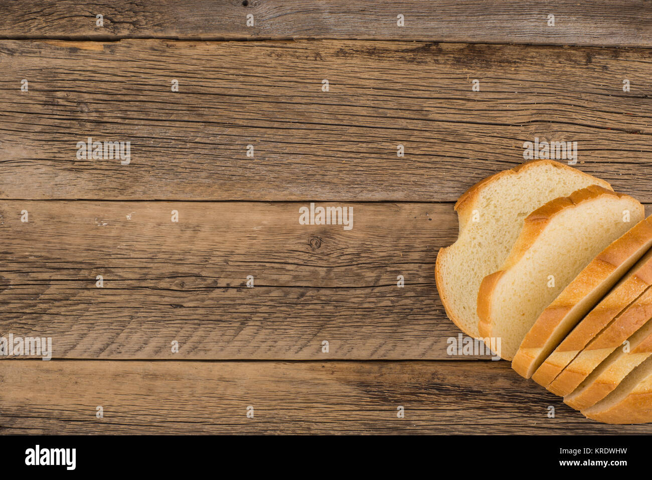 Sliced bread on an old wooden table Stock Photo - Alamy