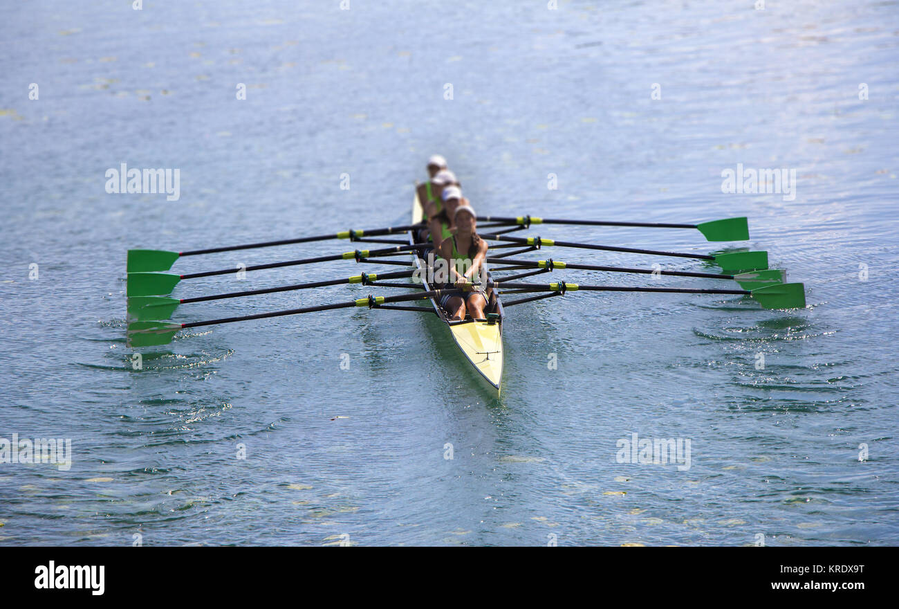 Team of rowing Four-oar women in boat Stock Photo - Alamy