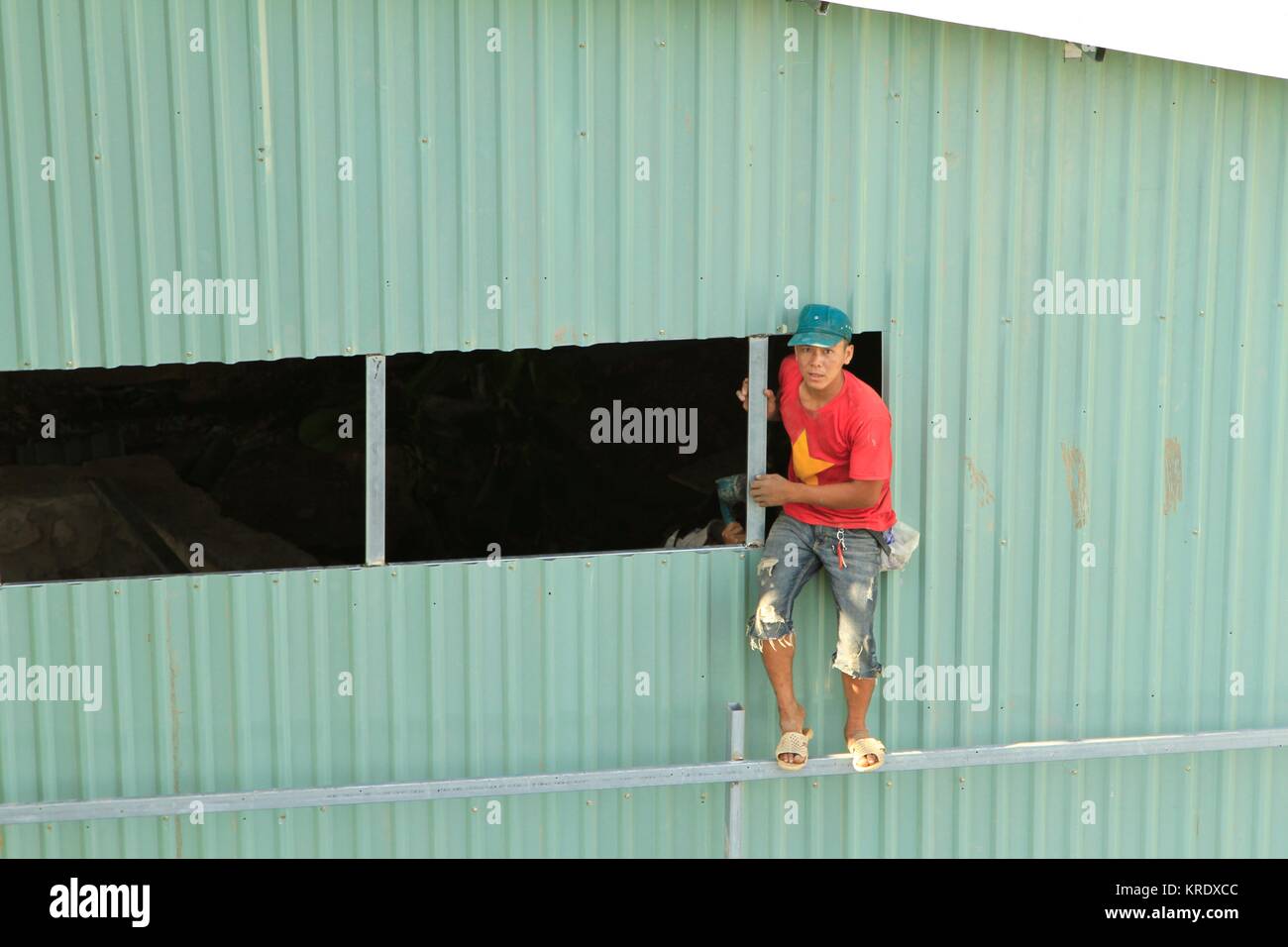 Man climbing out of window hi-res stock photography and images - Alamy