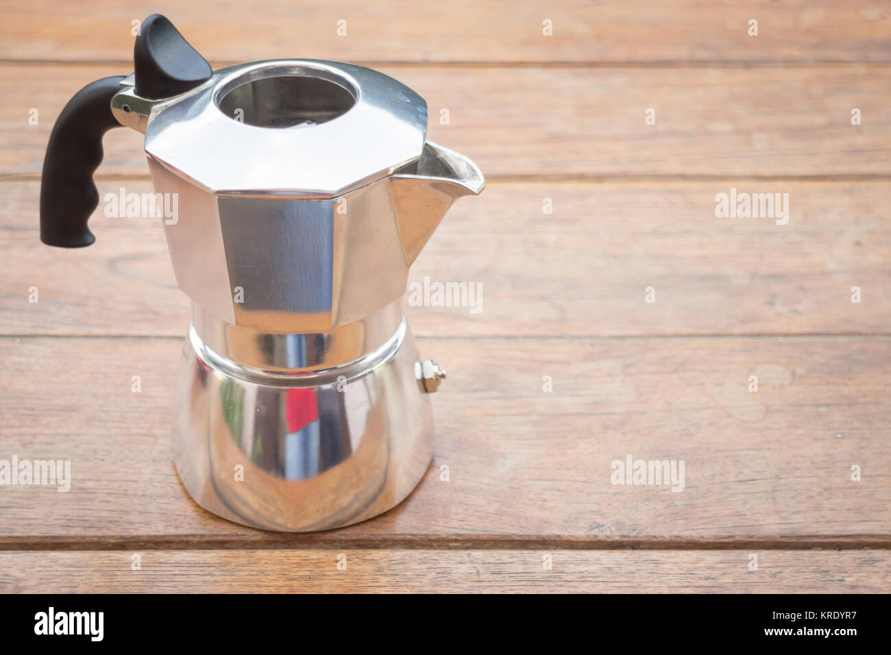 Metal coffee maker on wooden table Stock Photo - Alamy