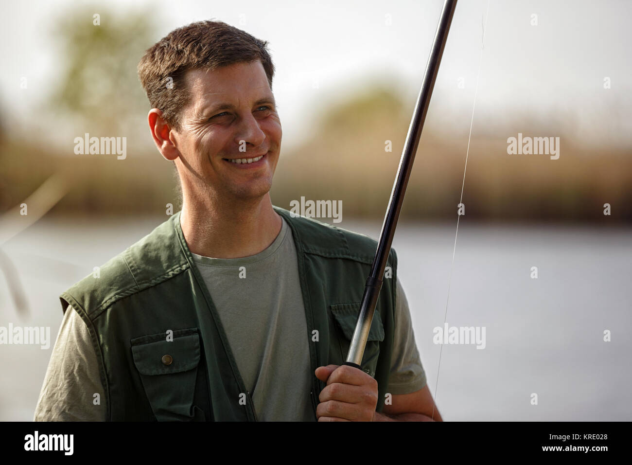 fishing- portrait of smiling fisherman Stock Photo - Alamy