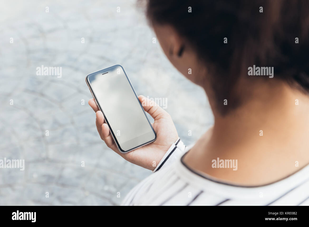 close up woman holding phone lifestyle in the city, third-person view ...