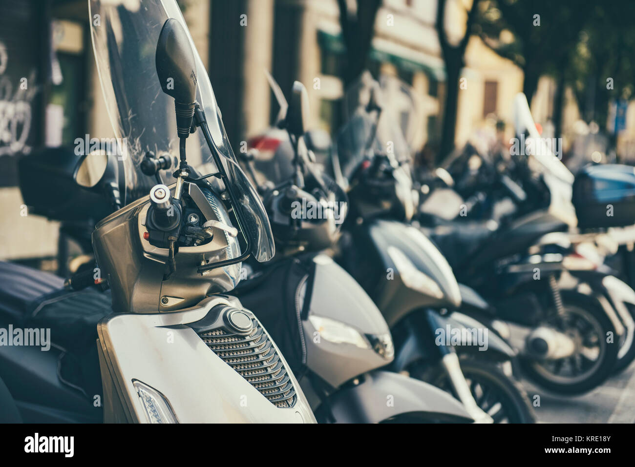 Scooters in a row in Italy Stock Photo - Alamy