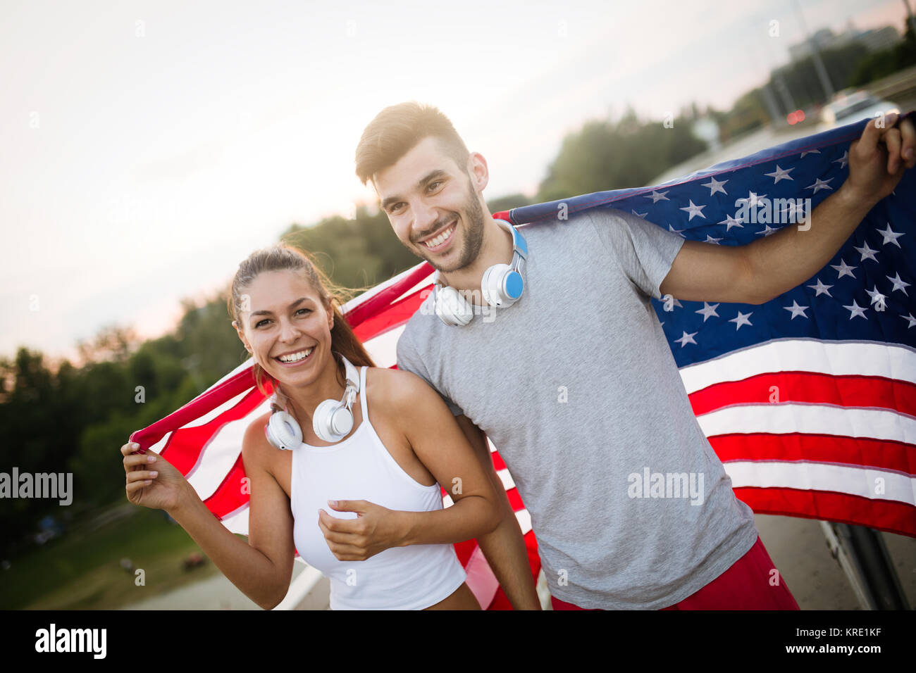American flag - woman and man USA sport athlete winner cheering waving ...