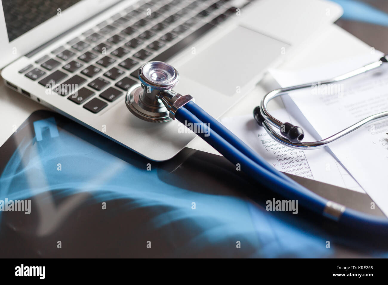 Doctor's desktop with medical equipment, computer and X-ray of human ...