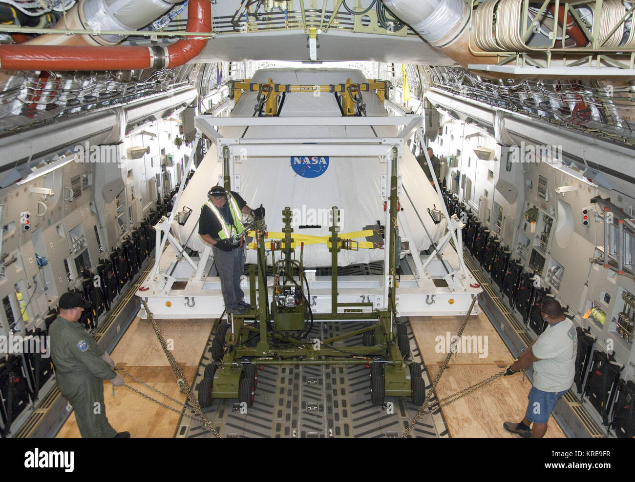 Technicians carefully position an Orion flight test crew module Stock ...