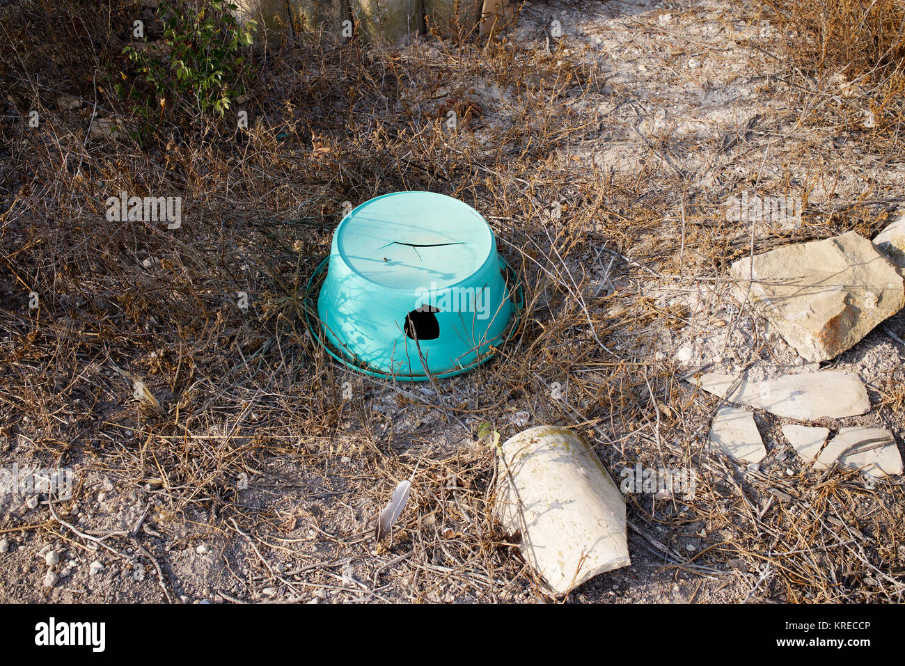 Upturned bucket with a hole Stock Photo - Alamy