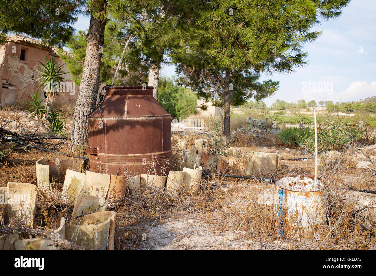 Rusty metal cylinder outside an abandoned farmhouse in the countryside ...