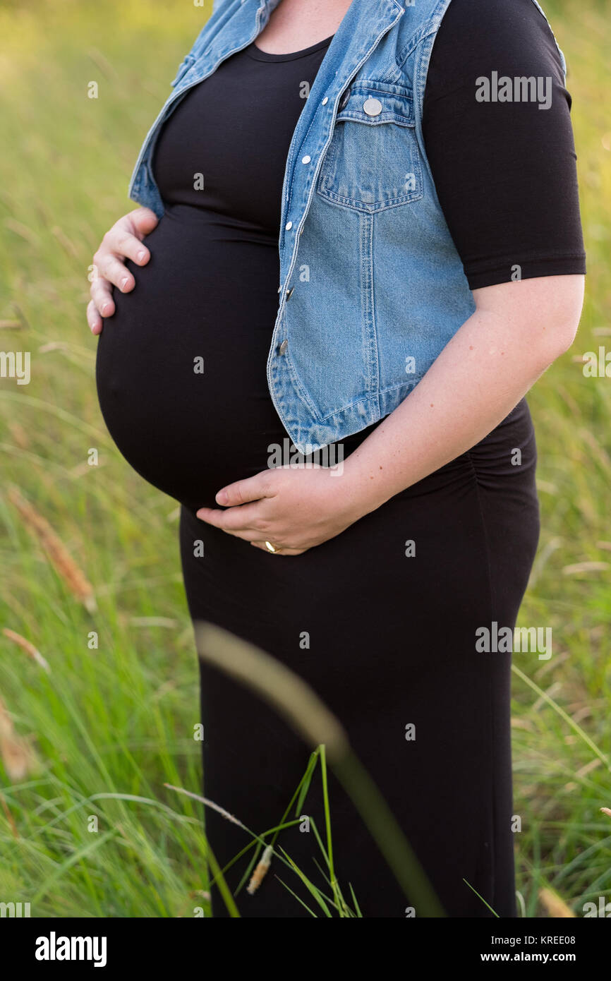 Maternity photo of a young woman with a short hair pixie cut in her ...