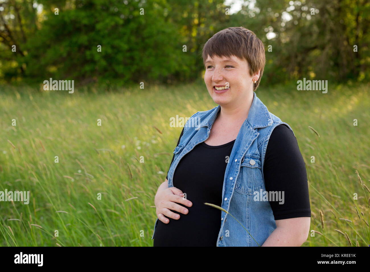 Maternity photo of a young woman with a short hair pixie cut in her ...