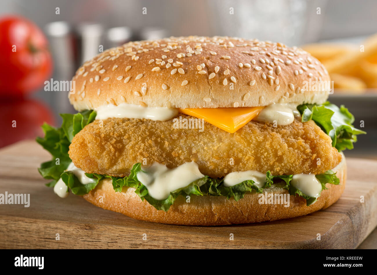 A delicious crispy fish burger with cheese, lettuce, and mayonnaise ...