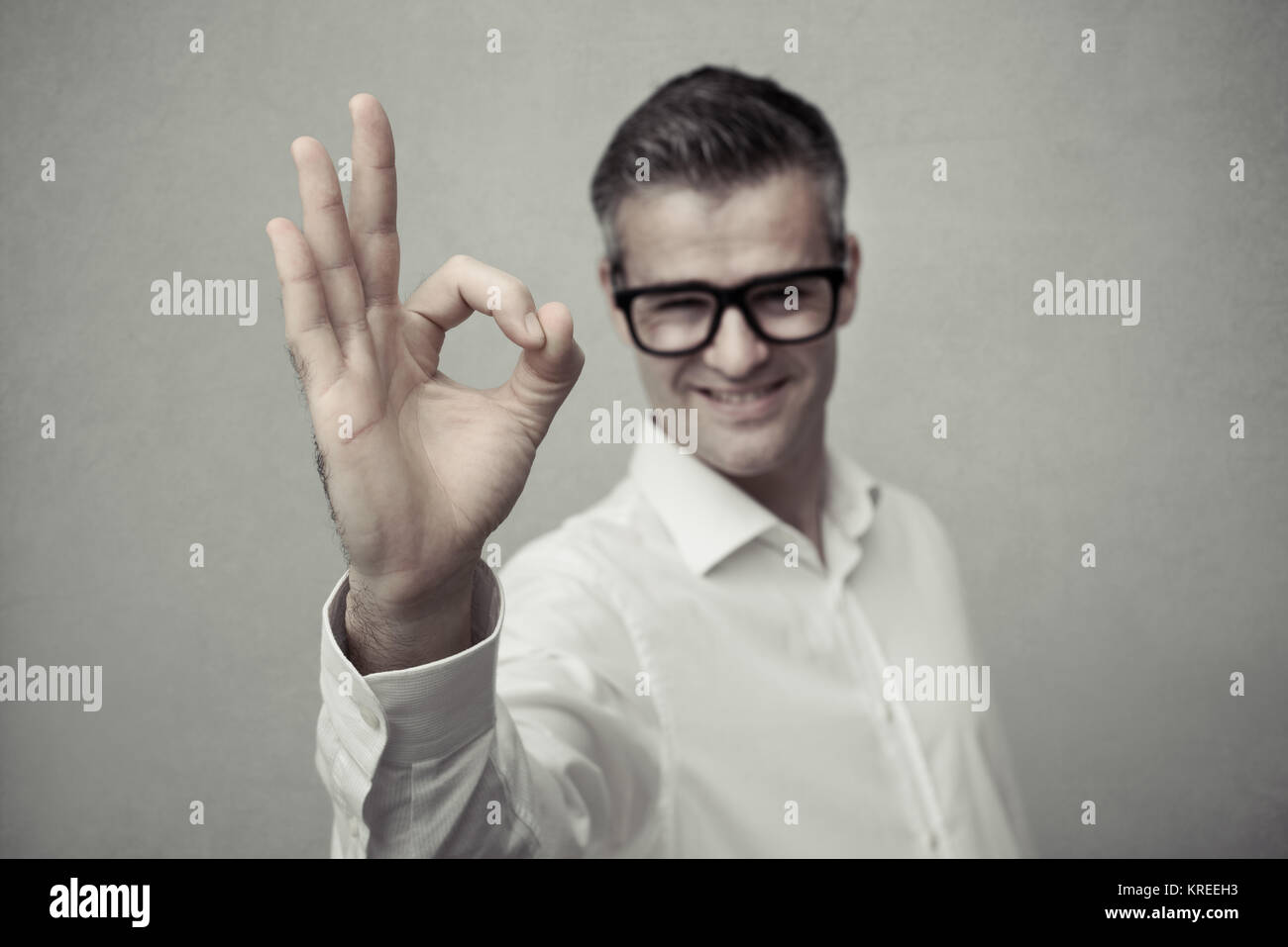 Satisfied happy man showing an OK sign and smiling at camera Stock ...