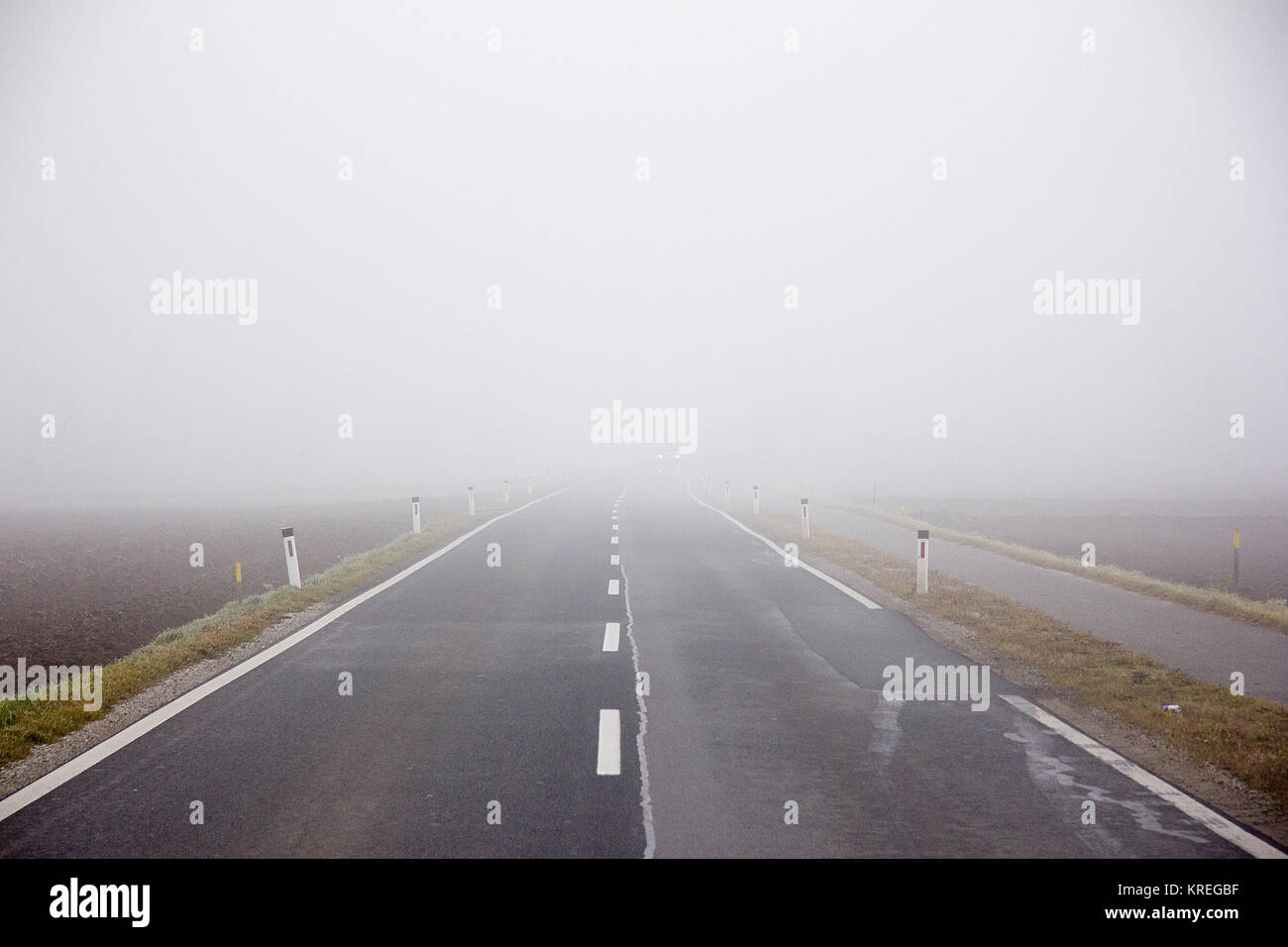 road without vehicles through rural area in fog Stock Photo - Alamy
