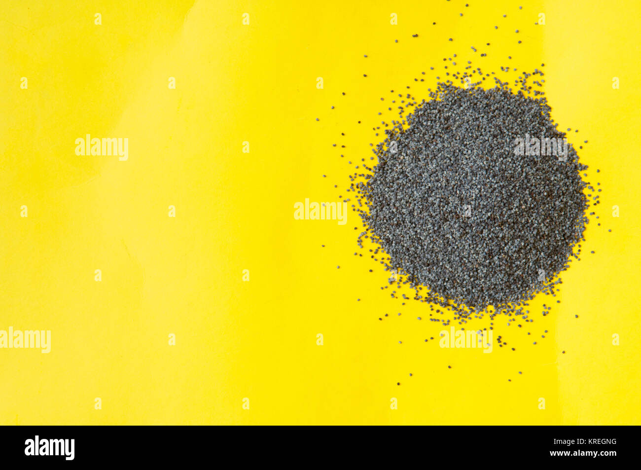 Poppy seeds isolated on yellow background poppy seed Stock Photo - Alamy