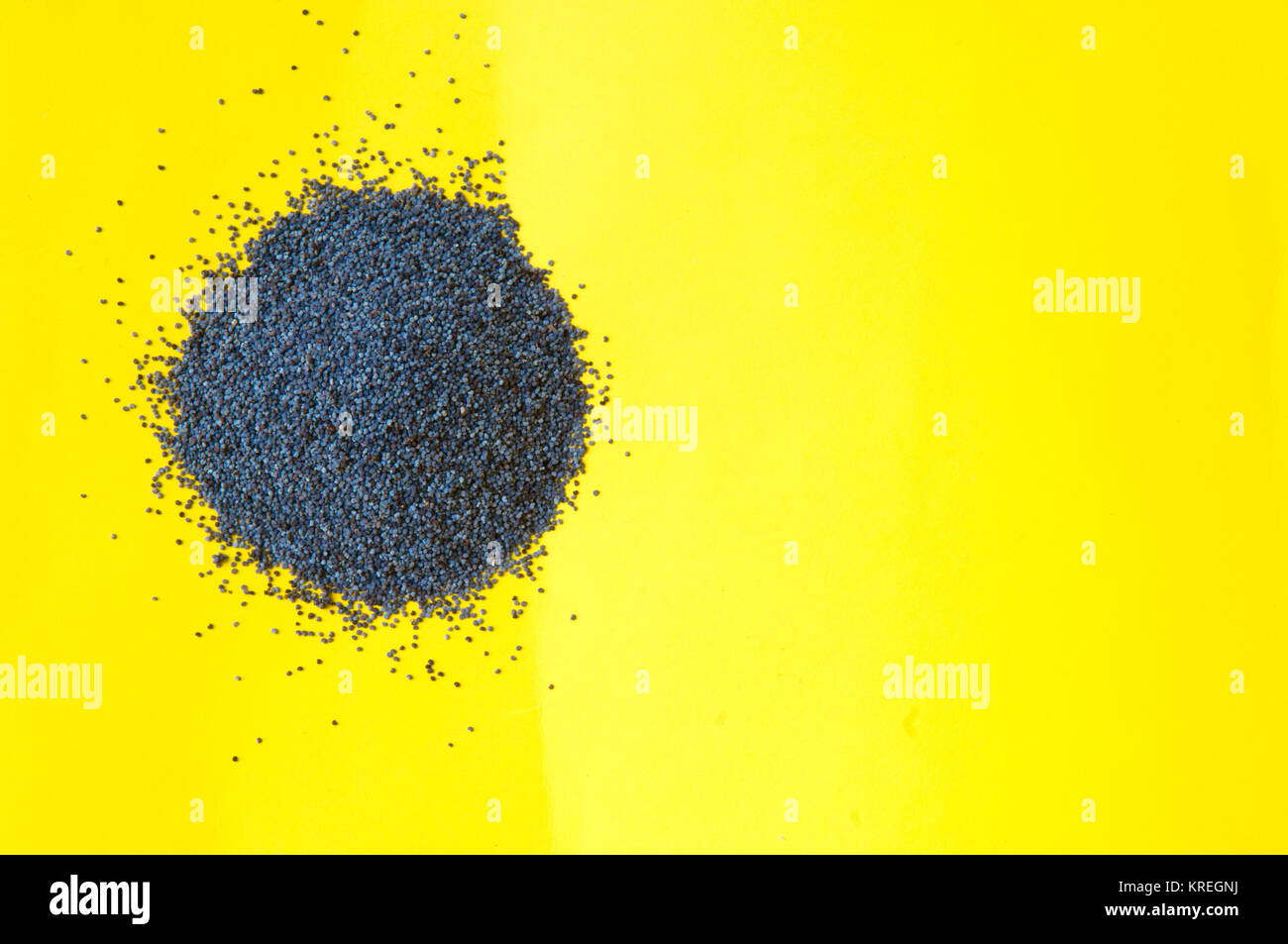 Poppy seeds isolated on yellow background poppy seed Stock Photo - Alamy