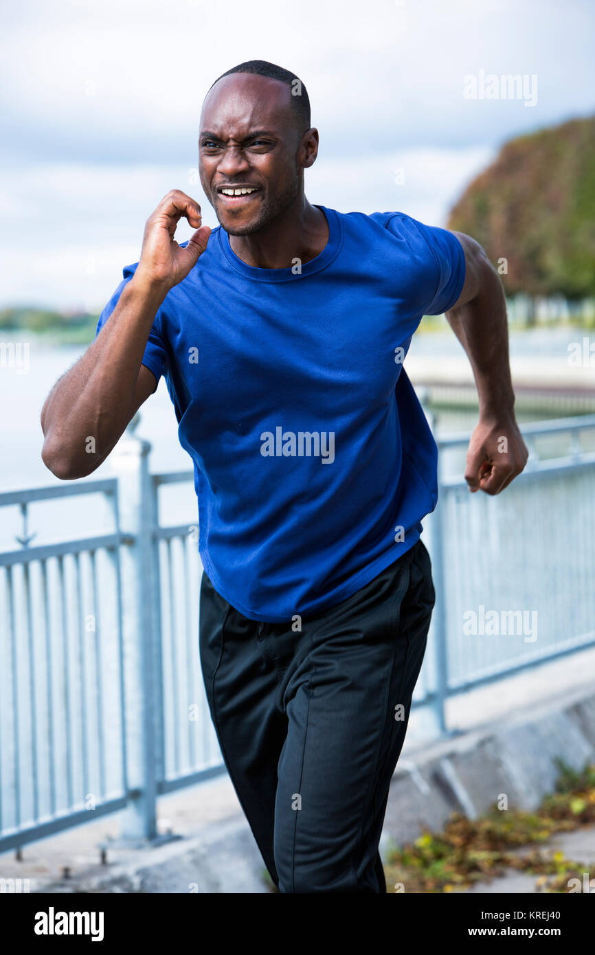 young man running outdoors Stock Photo - Alamy