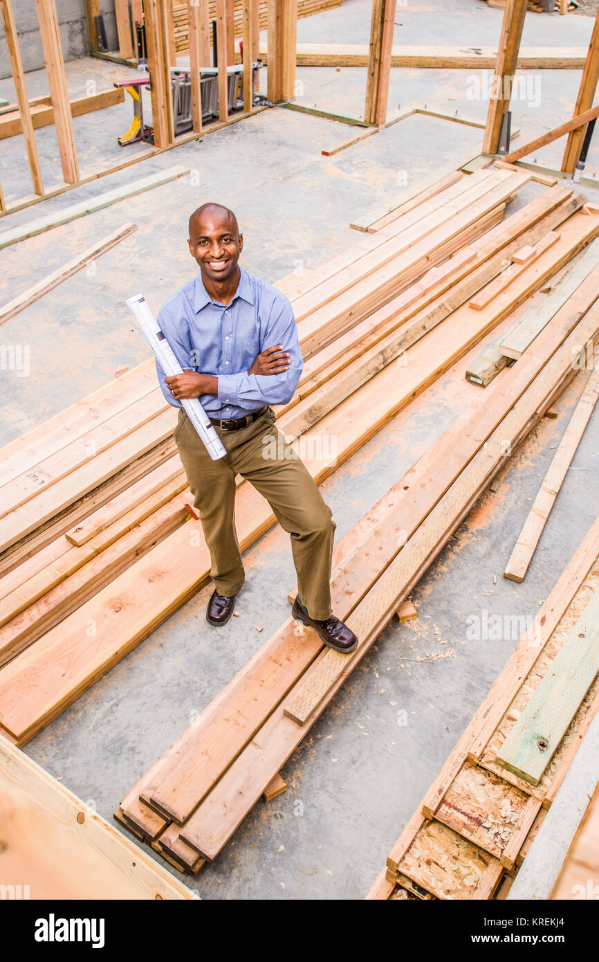 A portrait of a professional man on a residential construction site ...