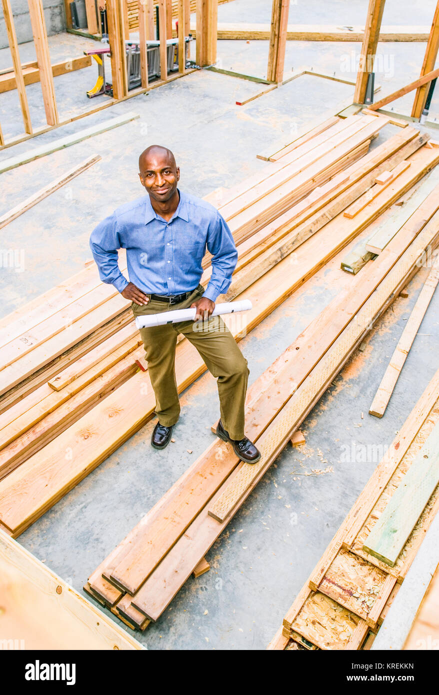 A portrait of a professional man on a residential construction site ...