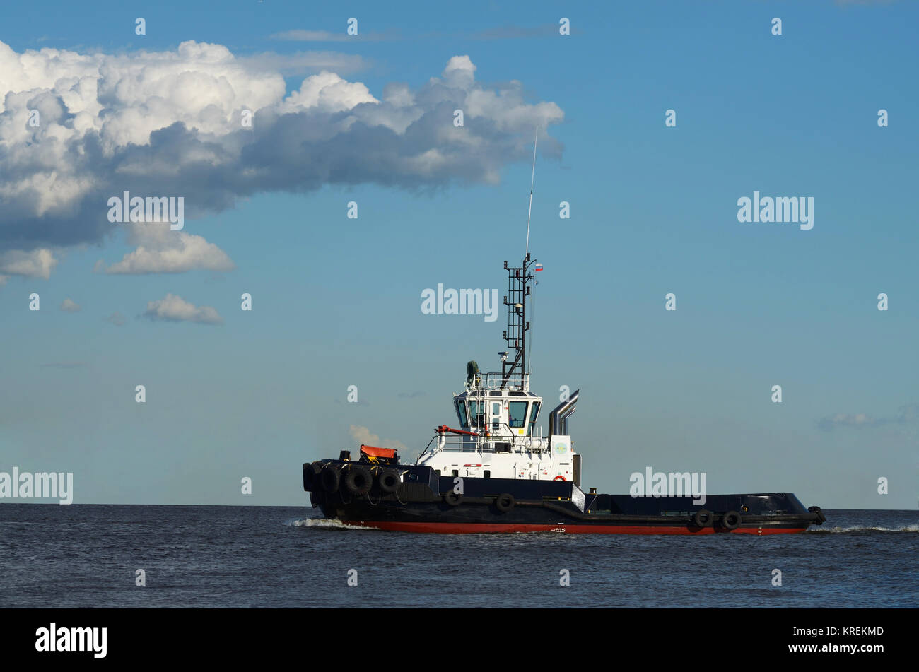 Port tow boat floats on the sea on background of blue sky Stock Photo ...