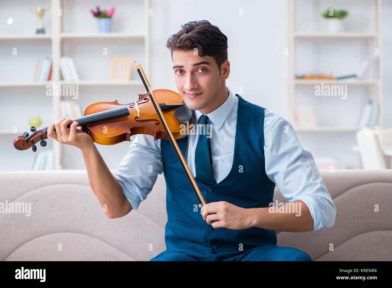 Young musician man practicing playing violin at home Stock Photo - Alamy