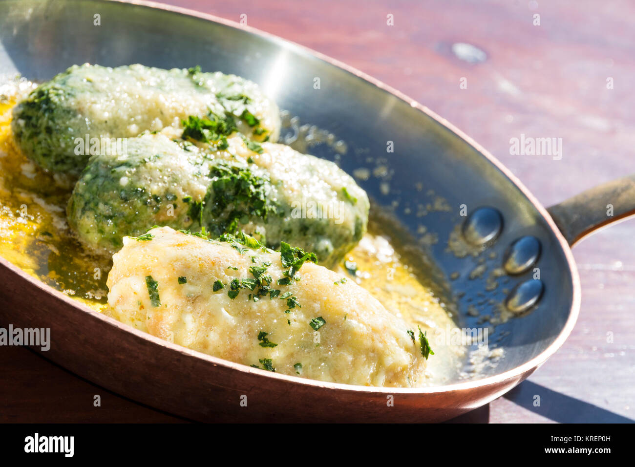 lunch at the alpine hut - spinach cakes and cheese socks Stock Photo ...