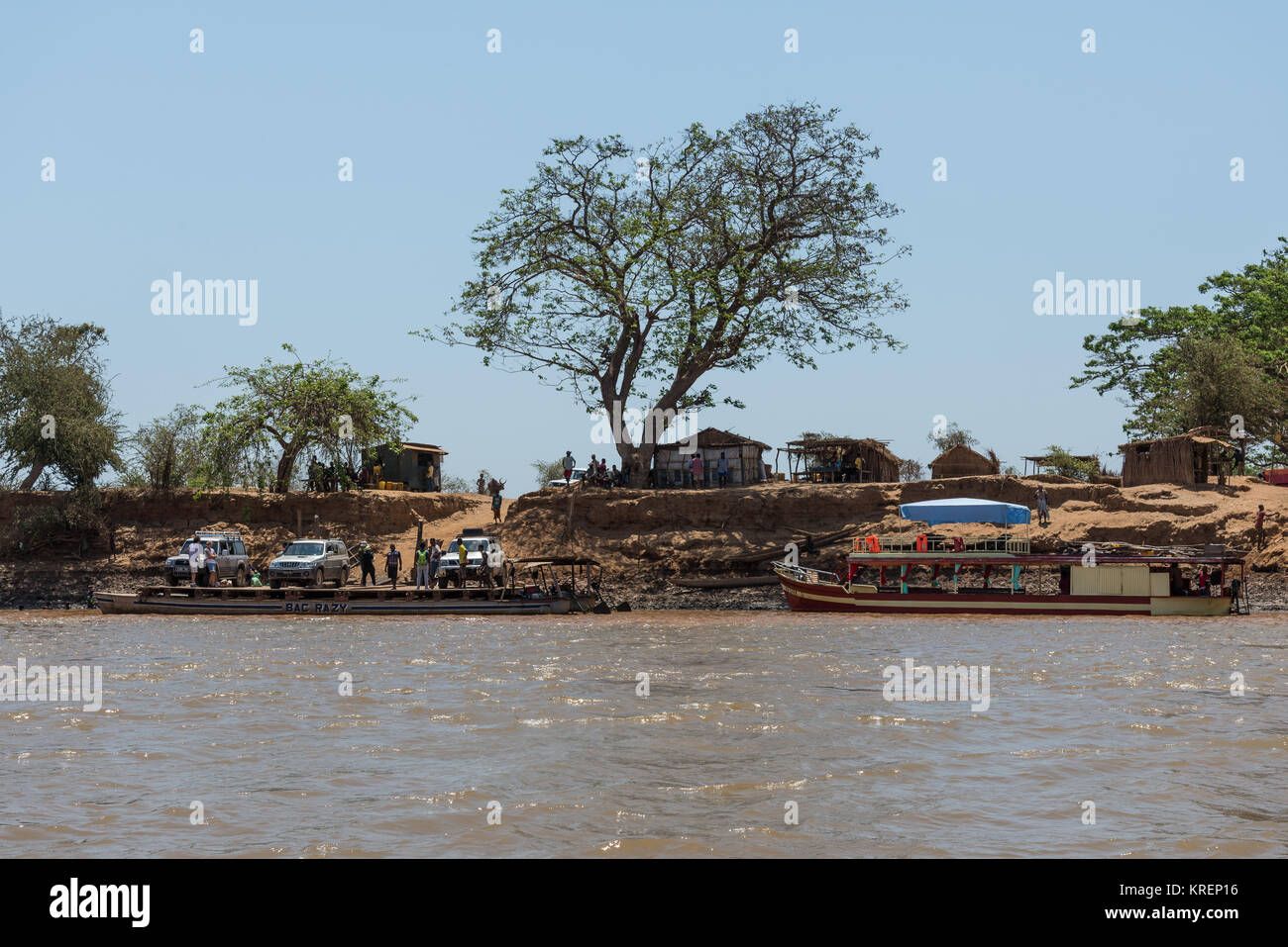 SUVs and passengers among busy traffic at the ferry port of Mania River ...