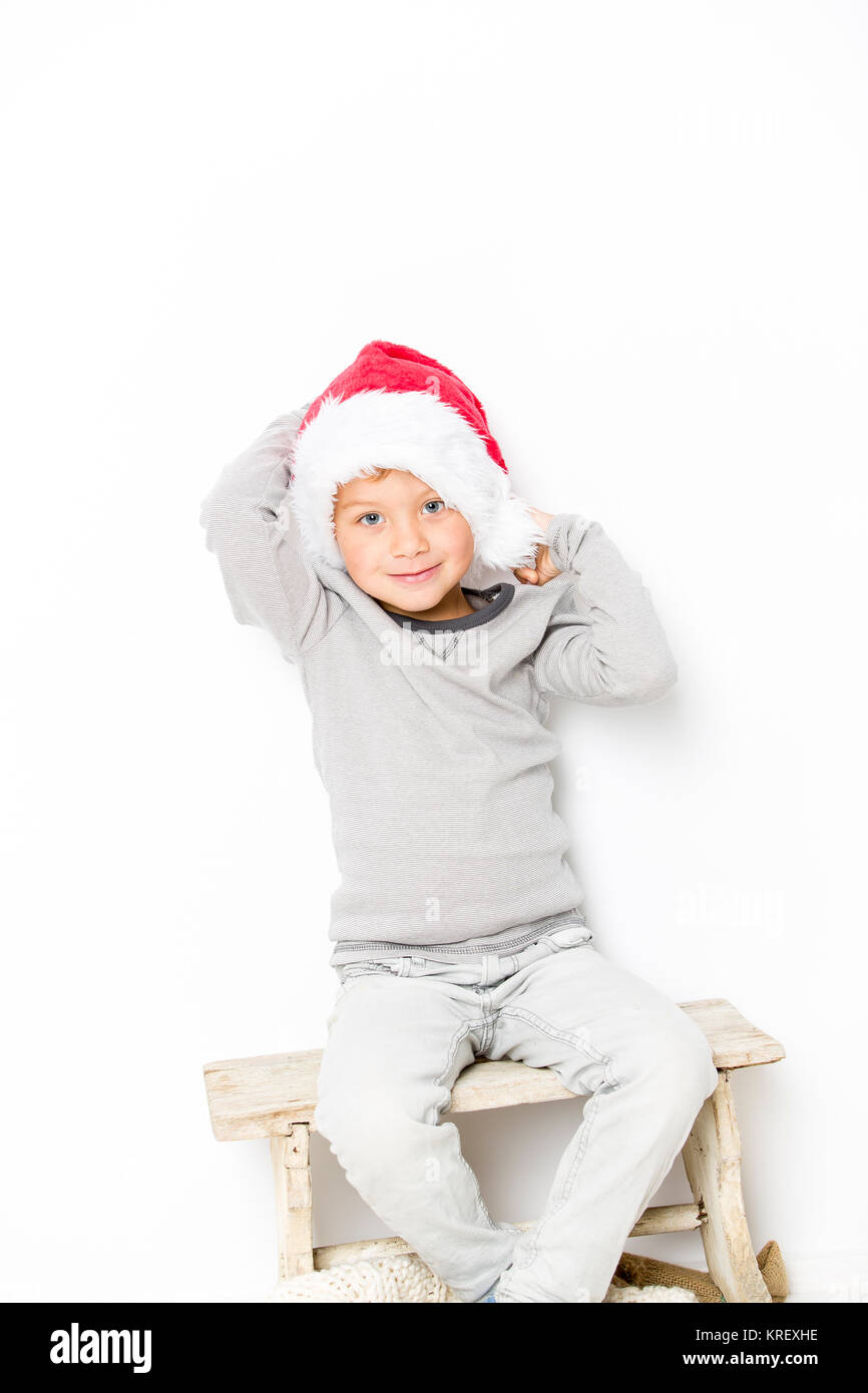 happy christmas boy in santa hat on white background Stock Photo - Alamy