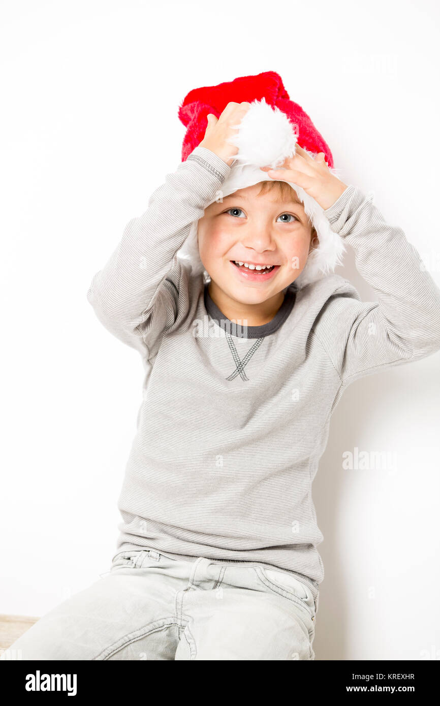 happy christmas boy in santa hat on white background Stock Photo - Alamy