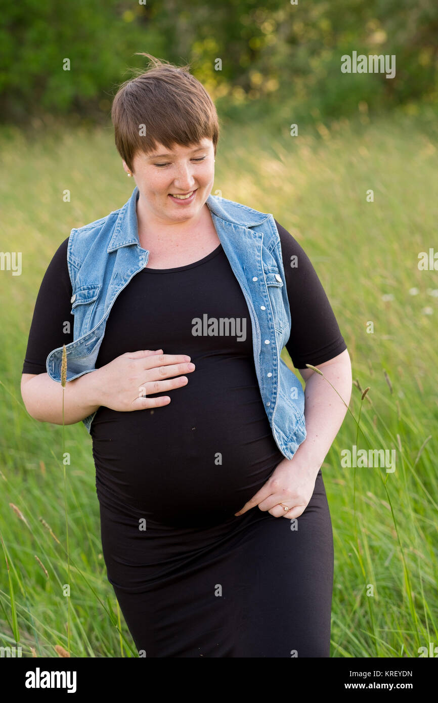 Maternity photo of a young woman with a short hair pixie cut in her ...