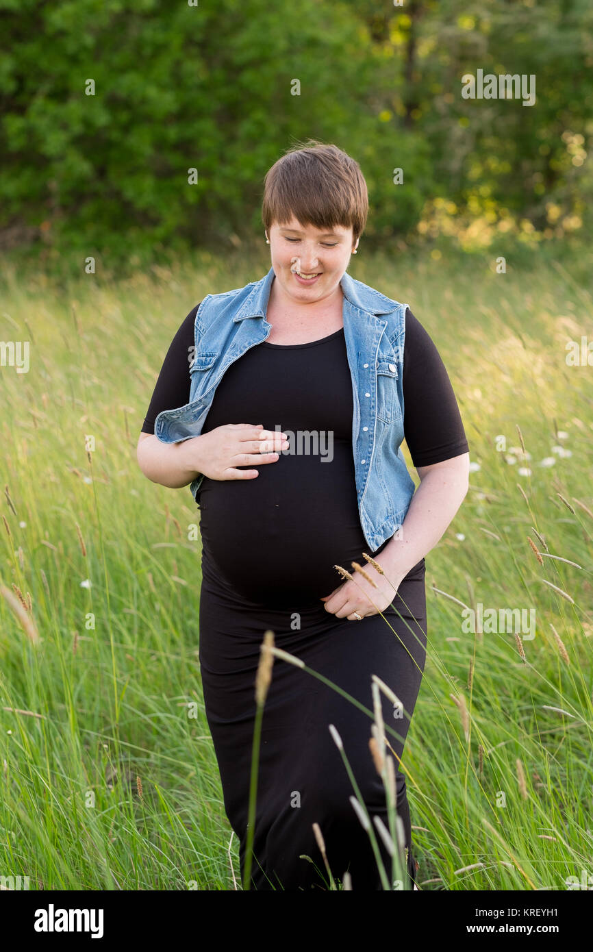 Maternity photo of a young woman with a short hair pixie cut in her ...