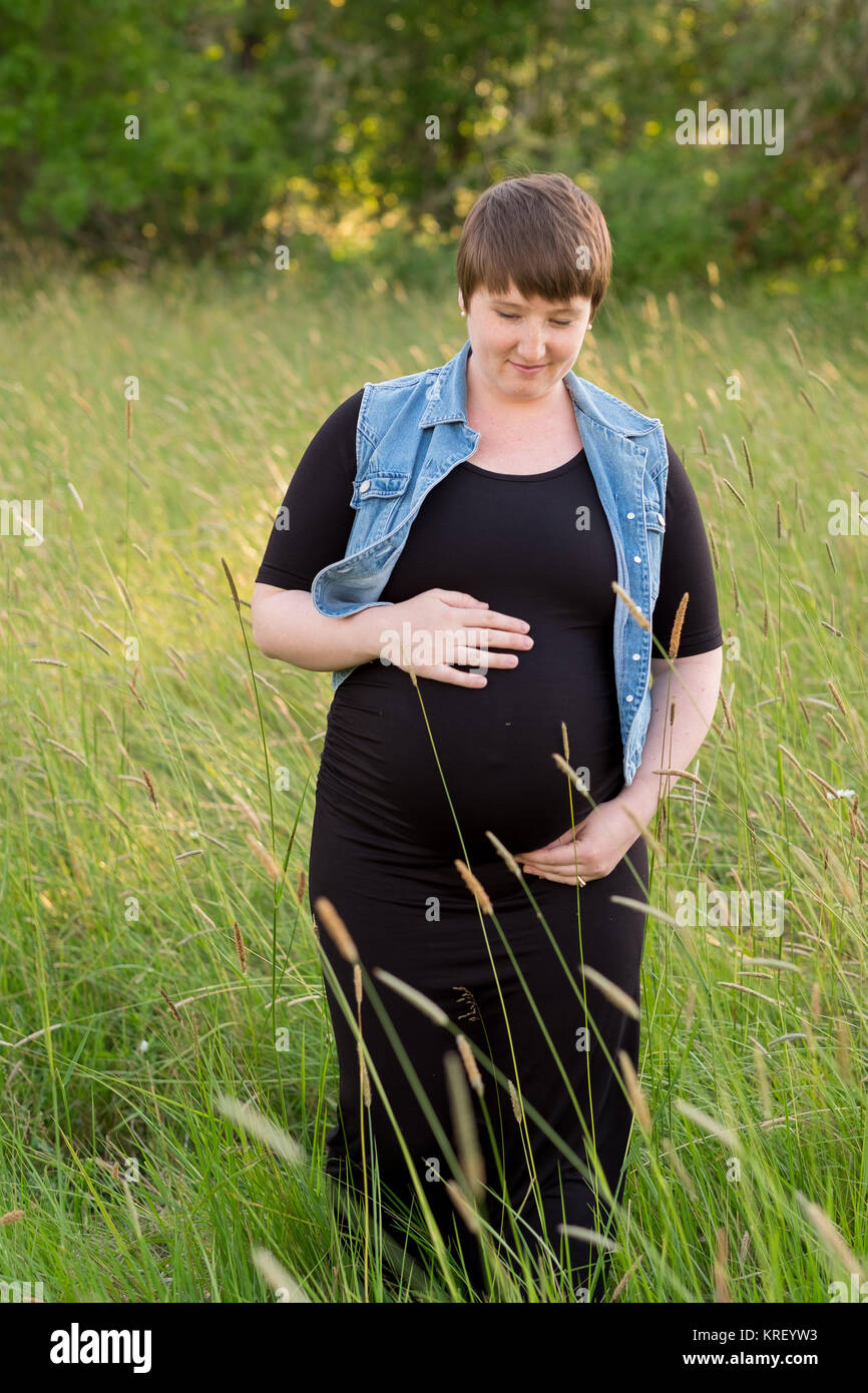 Maternity photo of a young woman with a short hair pixie cut in her ...