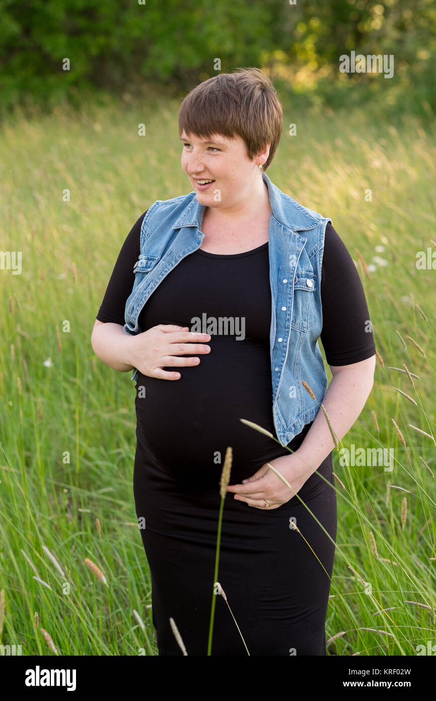 Maternity photo of a young woman with a short hair pixie cut in her ...