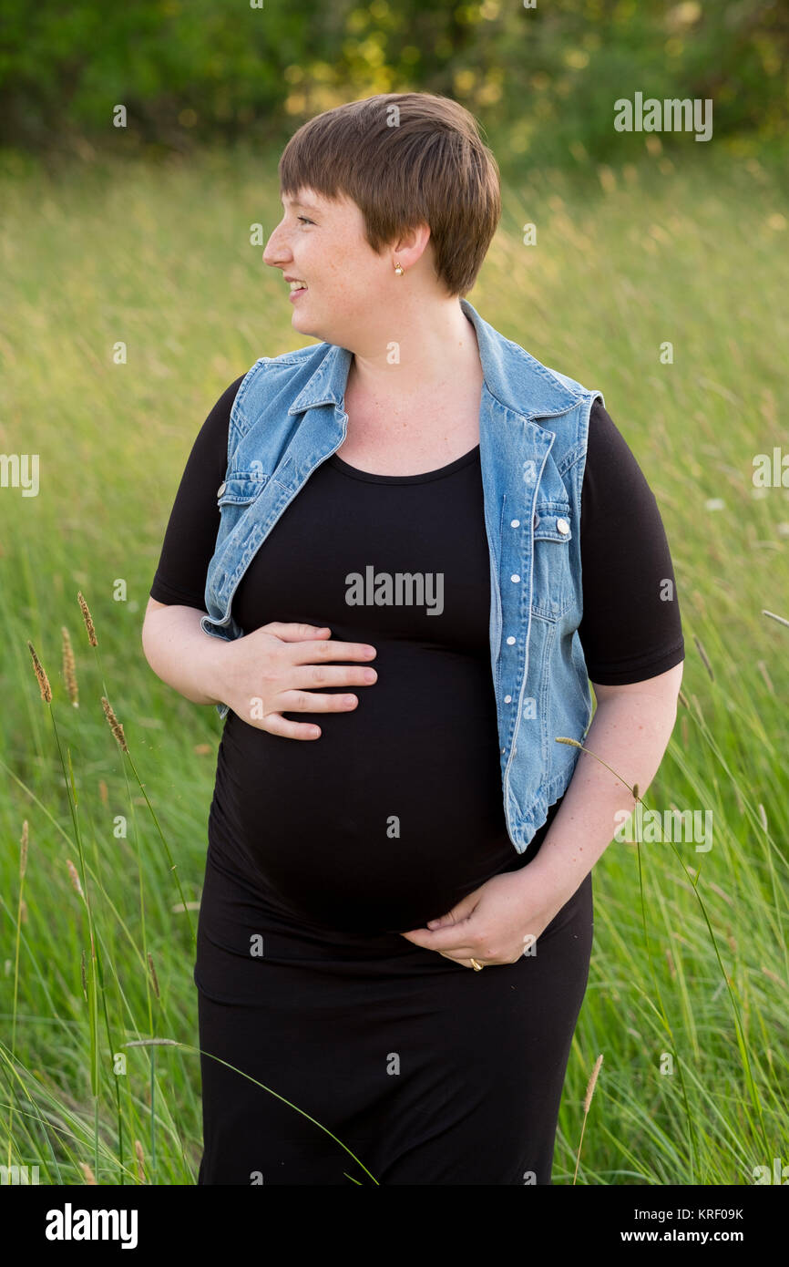 Maternity photo of a young woman with a short hair pixie cut in her ...