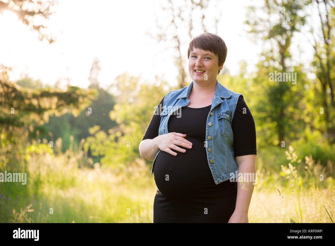 Maternity photo of a young woman with a short hair pixie cut in her ...
