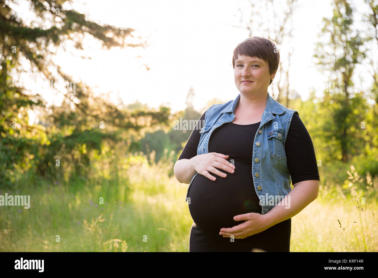 Maternity photo of a young woman with a short hair pixie cut in her ...