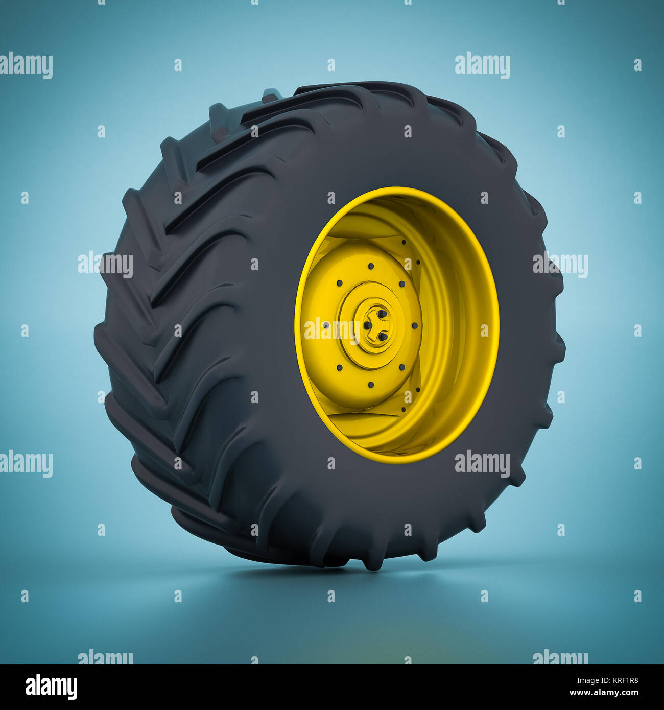 Tractor wheel isolated on blue background Stock Photo - Alamy