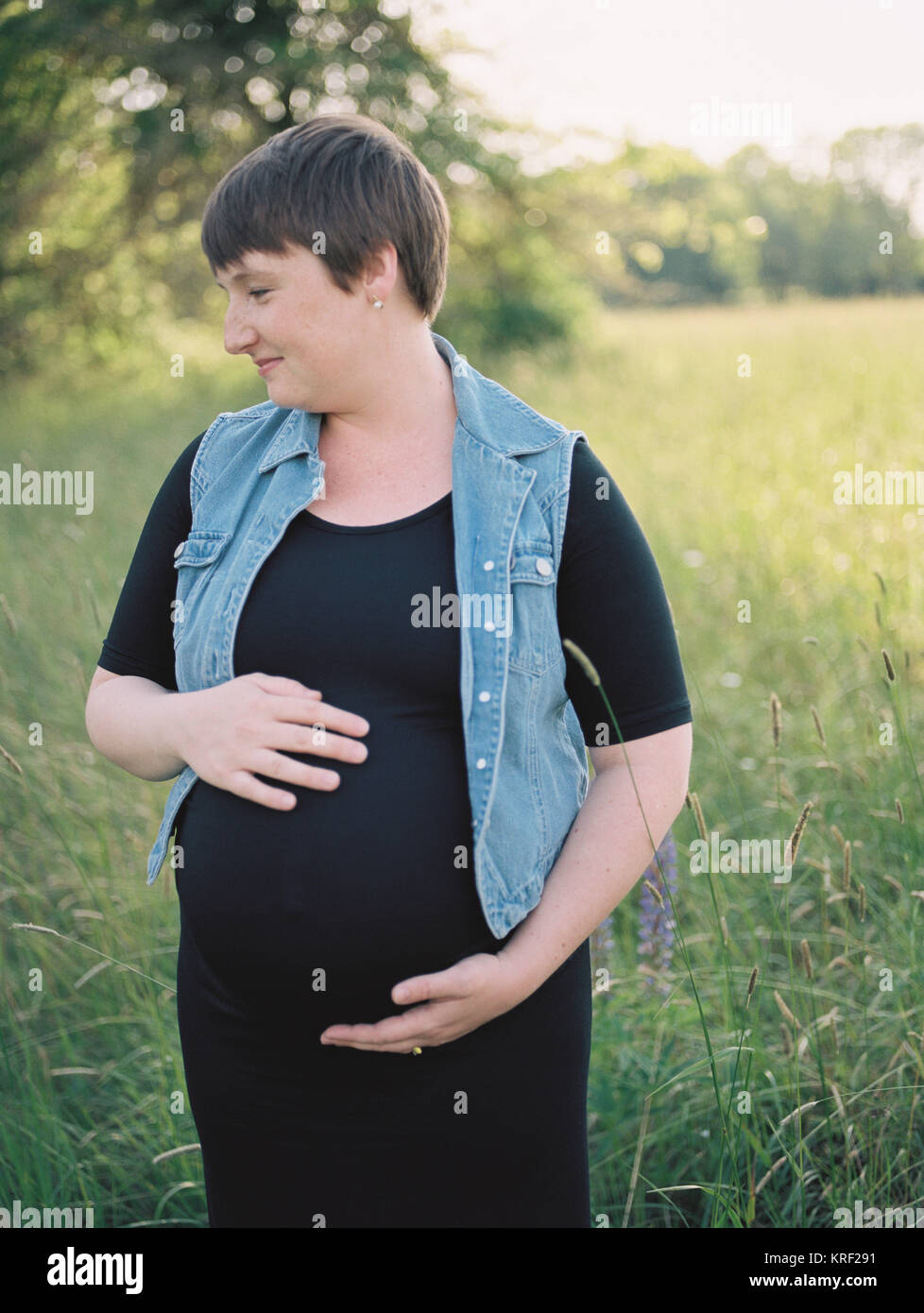 Maternity photo of a young woman with a short hair pixie cut in her ...