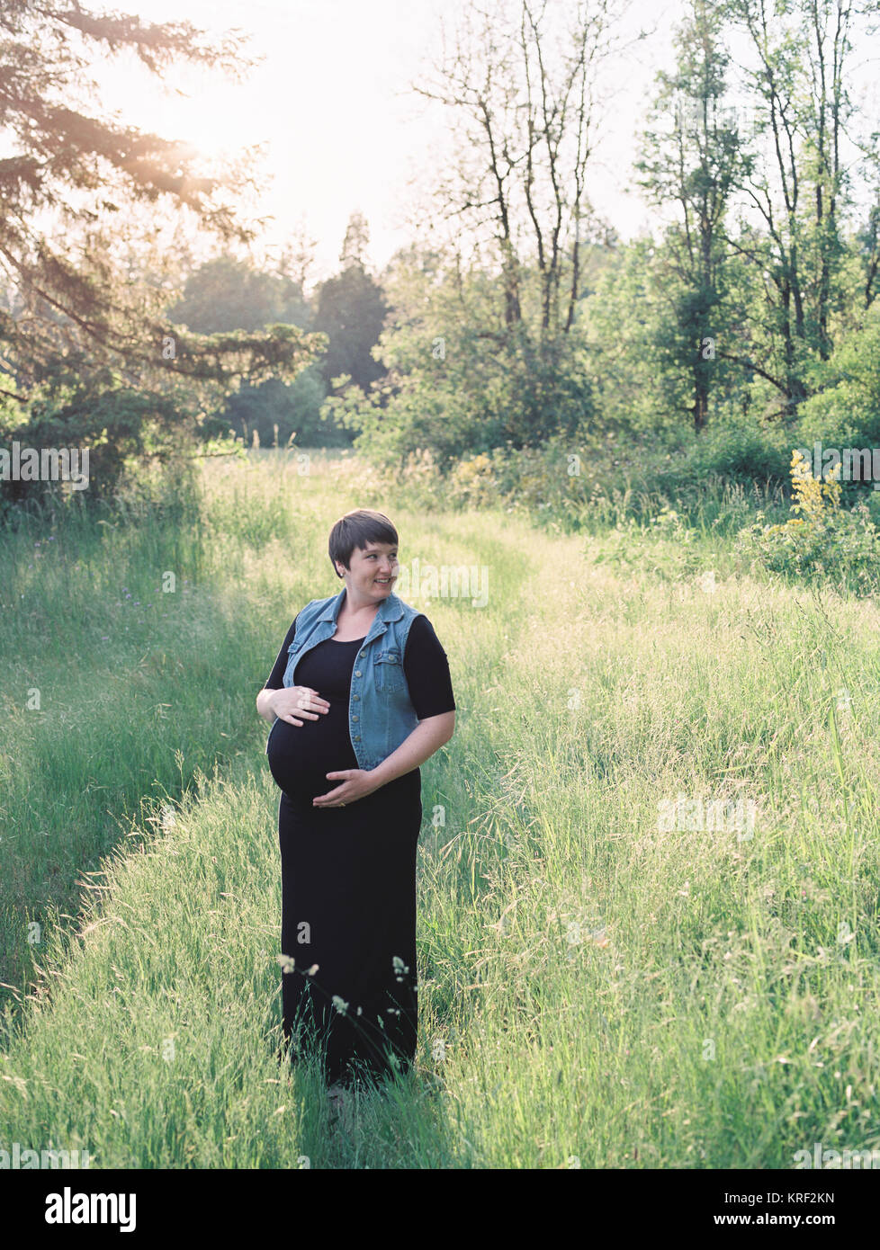 Maternity photo of a young woman with a short hair pixie cut in her ...