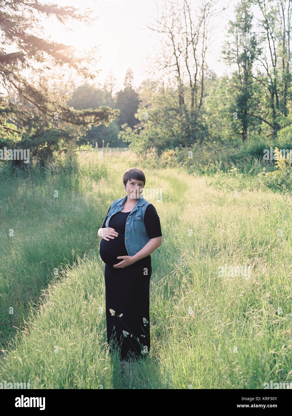Maternity photo of a young woman with a short hair pixie cut in her ...