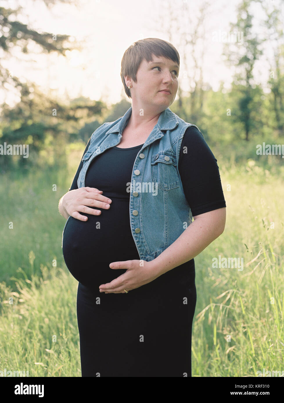 Maternity photo of a young woman with a short hair pixie cut in her ...