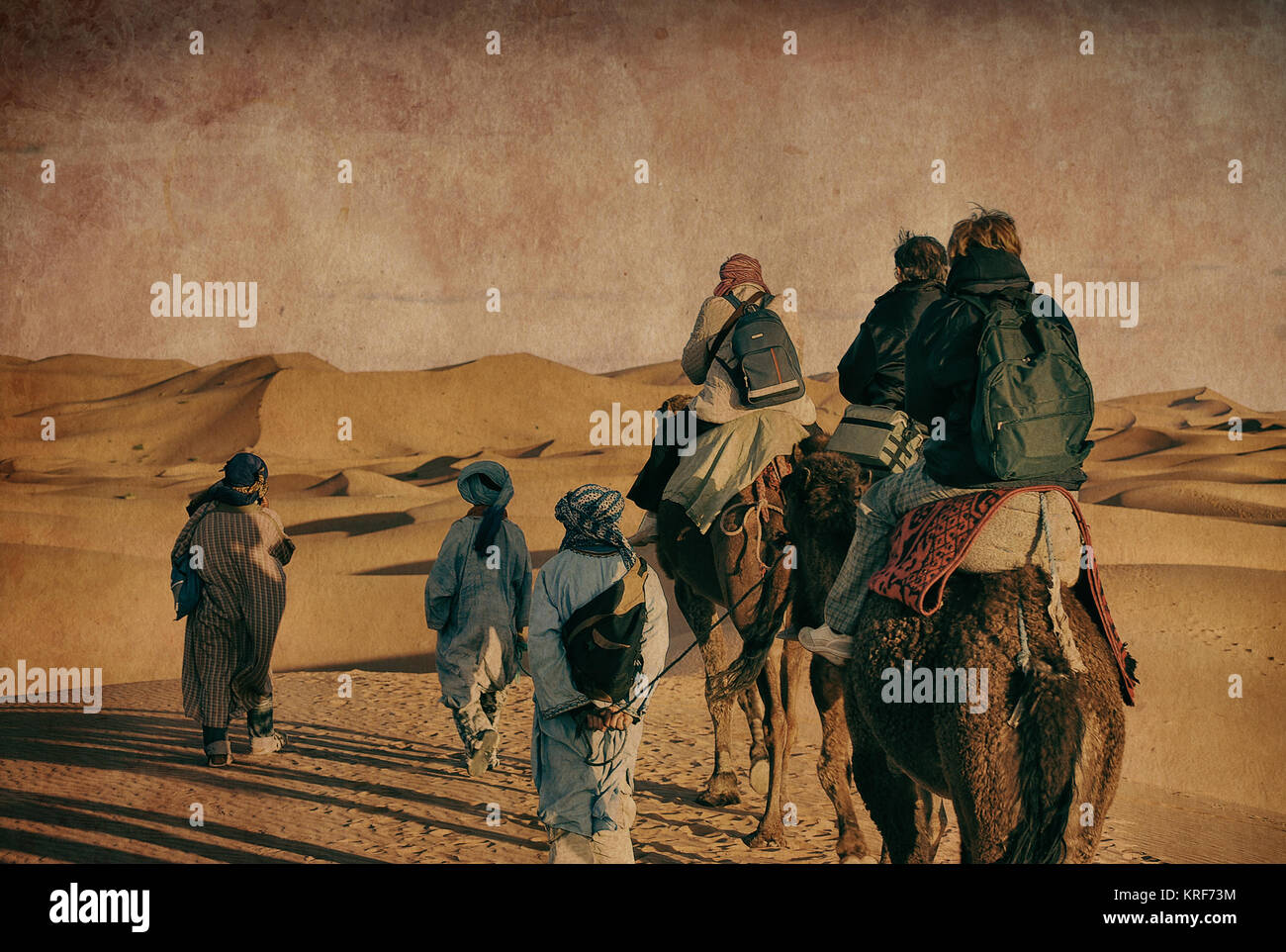 Camel caravan going through the desert Stock Photo - Alamy